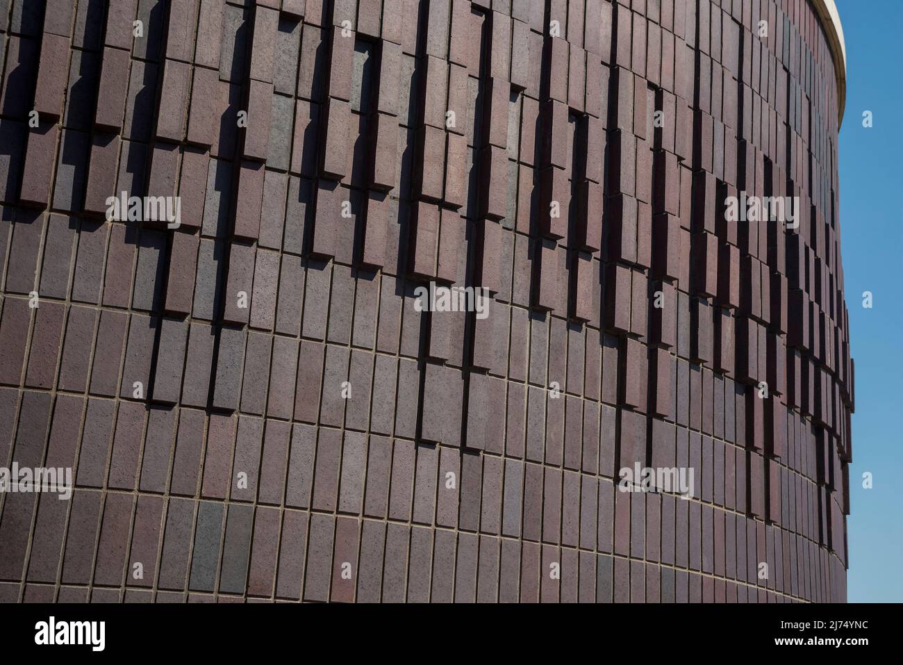Brick / blockwork laid in stepped relief vertical lines as decoration ...