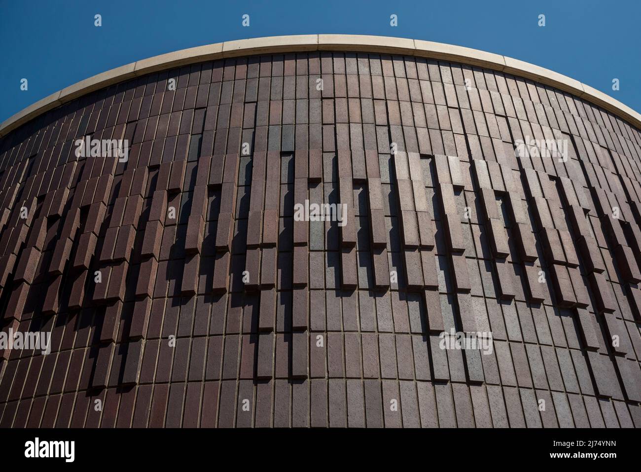 Brick / blockwork laid in stepped relief vertical lines as decoration to a small cylindrical ...