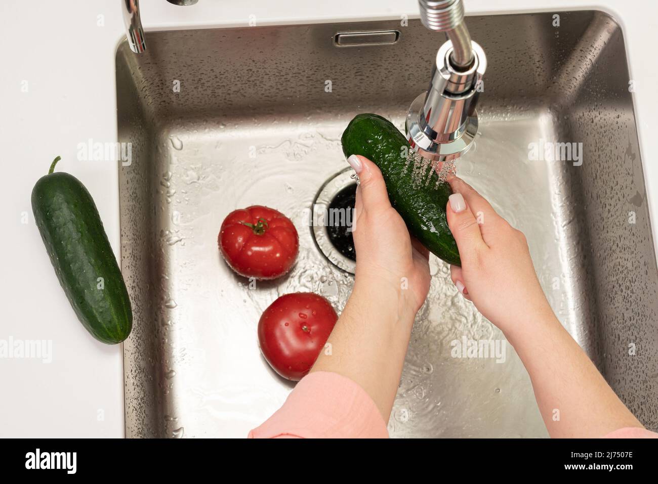 woman washing vegetables in the kitchen over the sink Stock Photo - Alamy