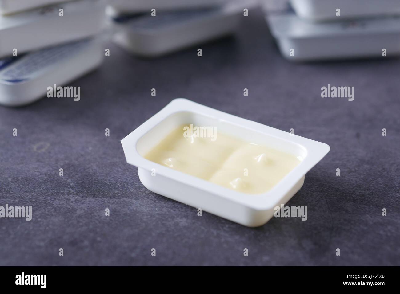 fresh butter in a small container on black Stock Photo - Alamy