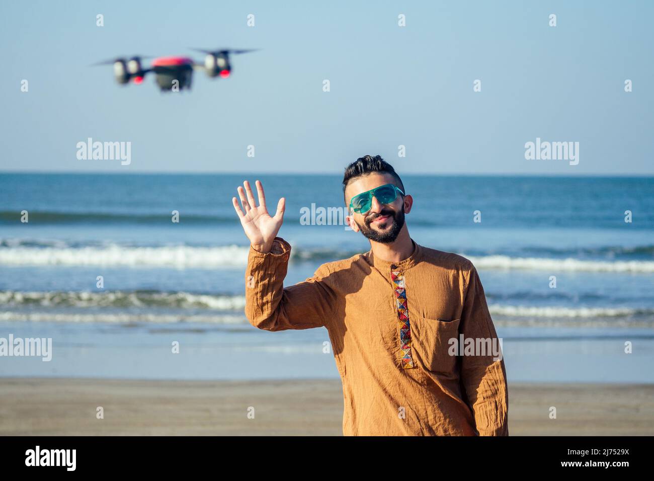 Drone remote control. Arabian man operating copter controller ...