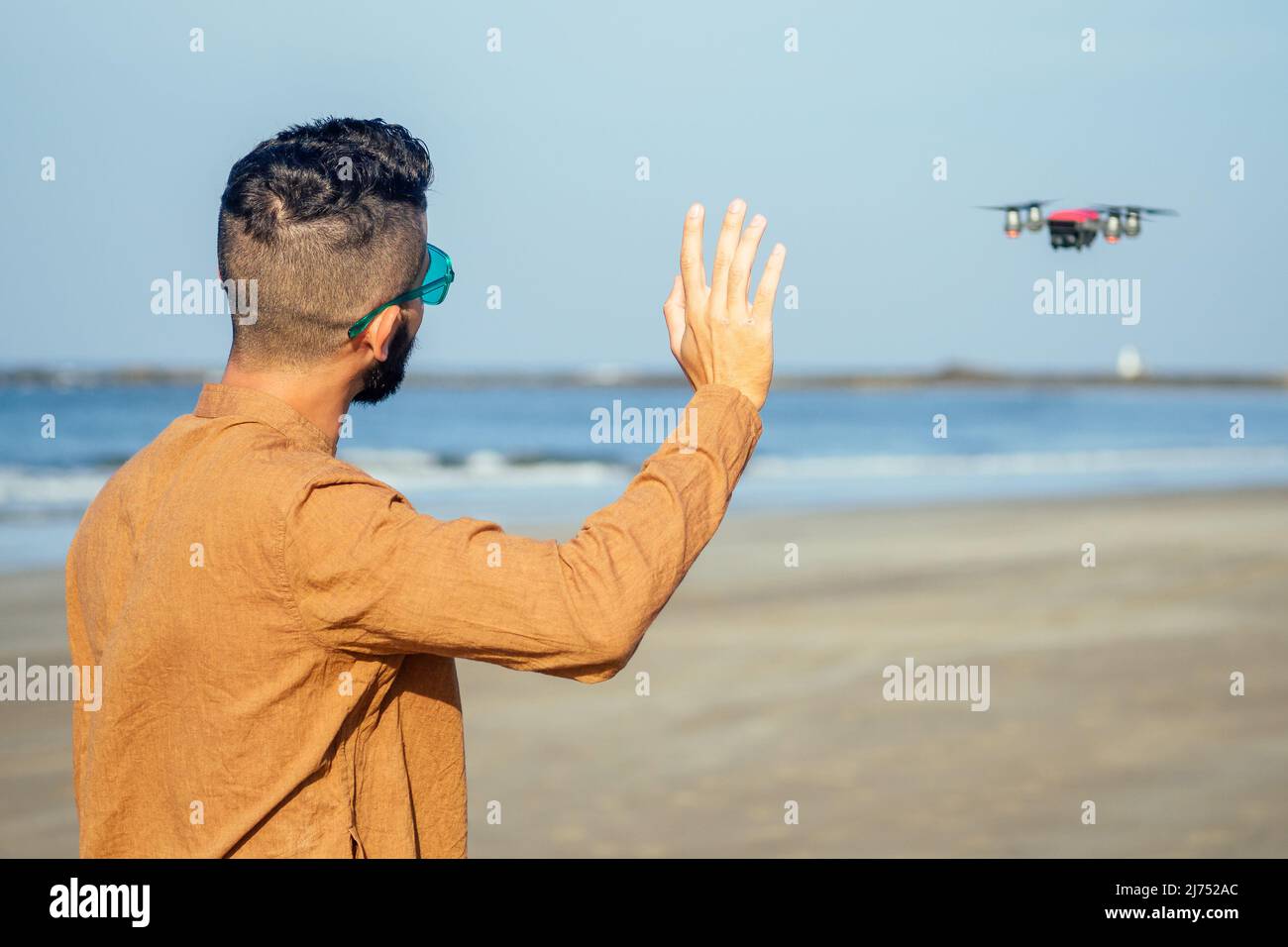 Drone remote control. Arabian man operating copter controller ...