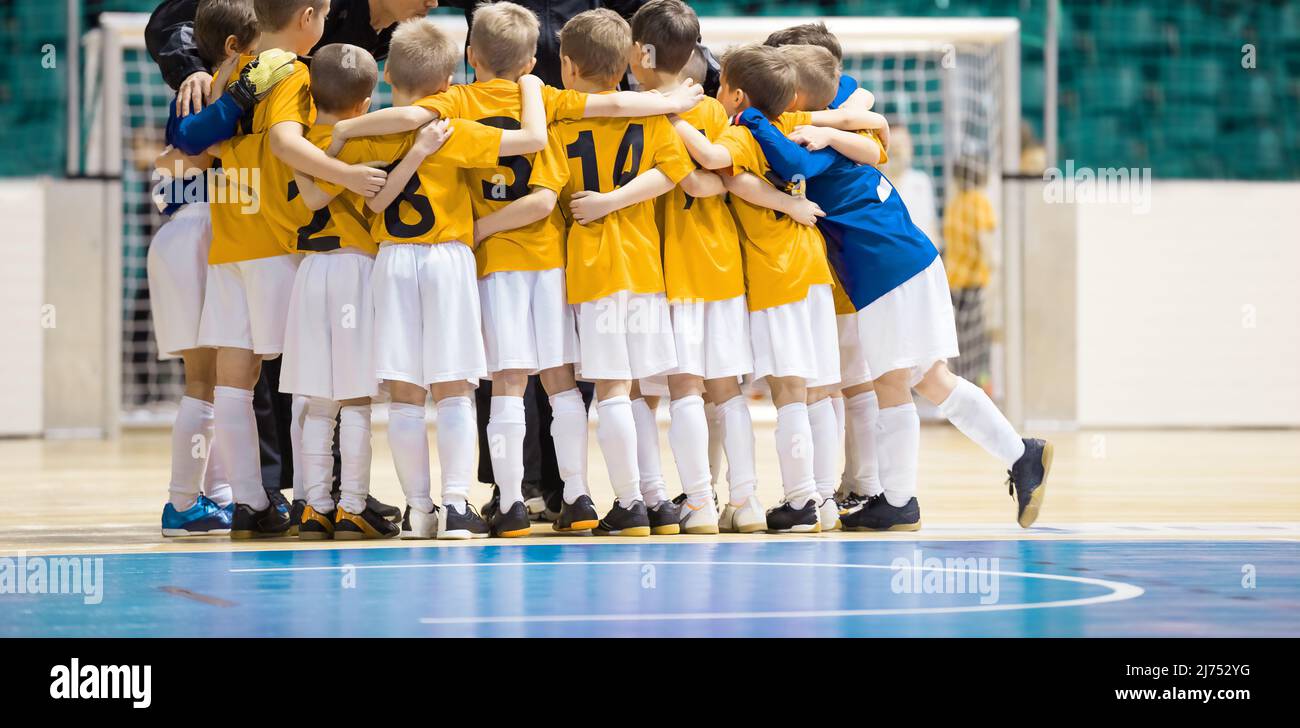 Coach giving young soccer futsal team advices before soccer tournament ...