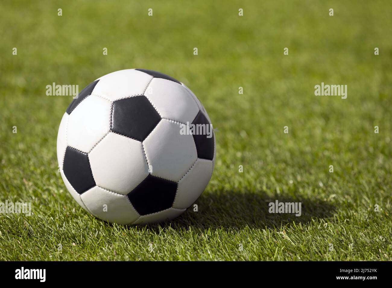 Classic soccer football ball on grass pitch. Side view on retro classic ...