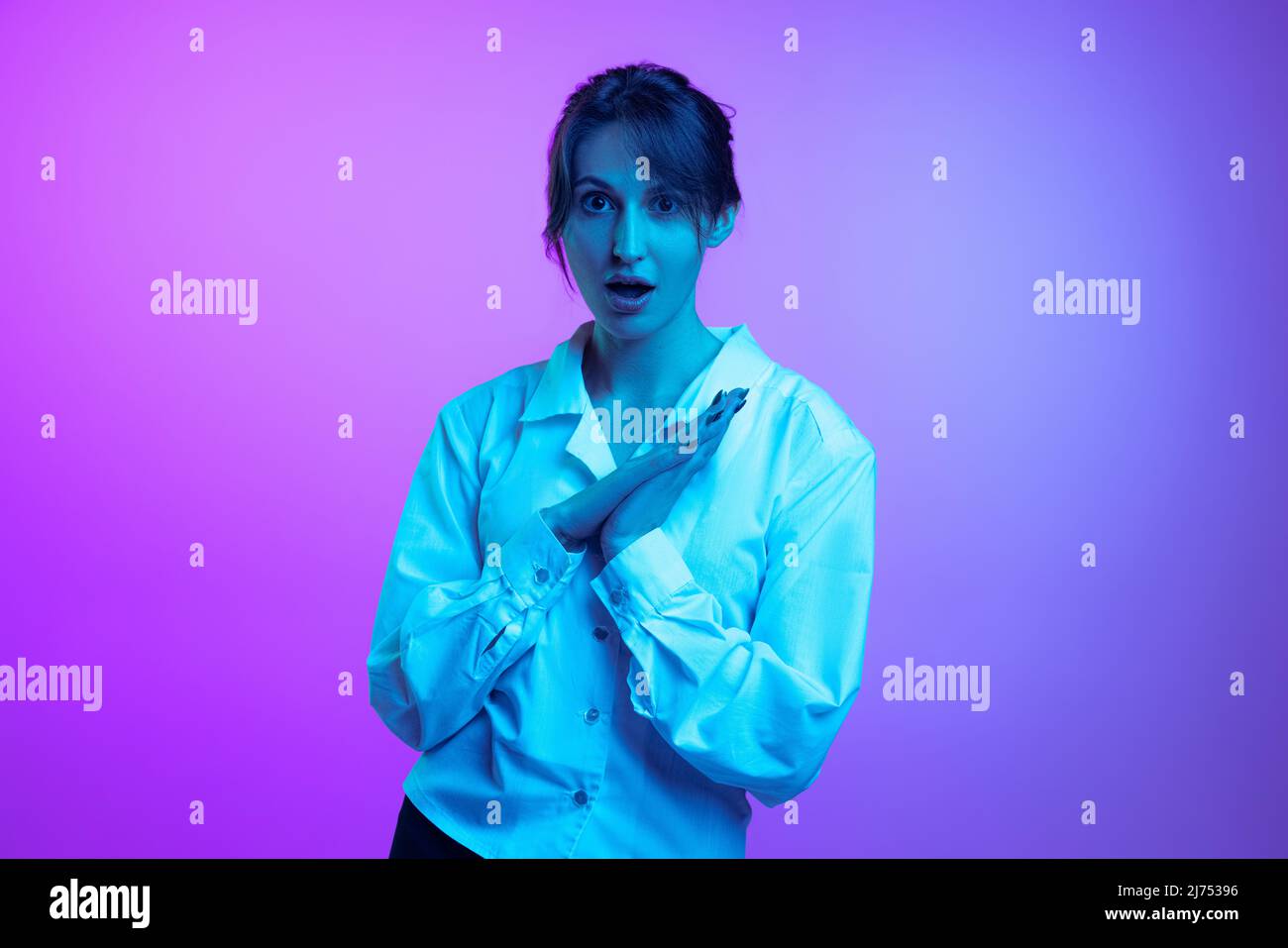 Shock, surprise. Young beautiful woman in white shirt isolated over ...