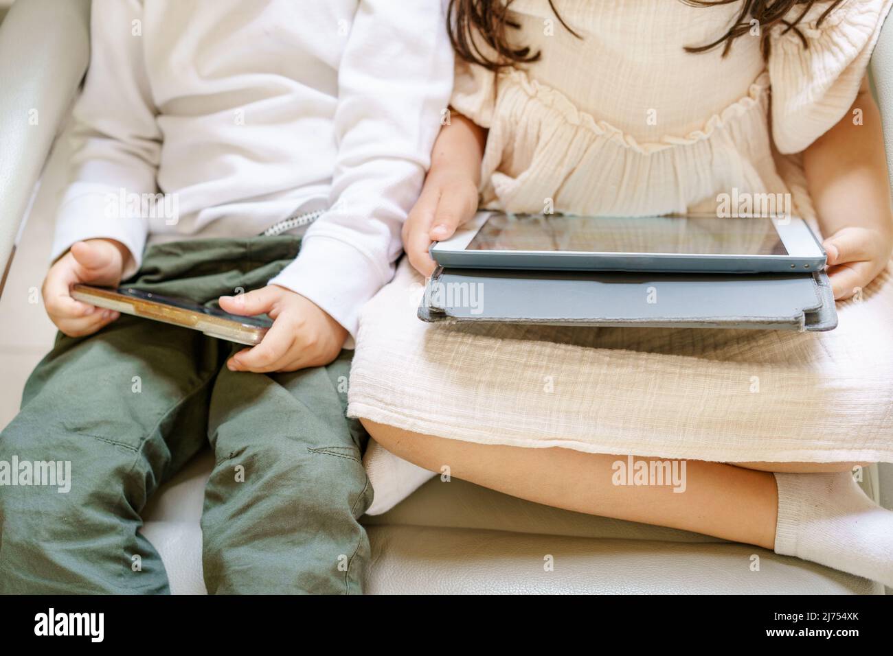 Children with tablet computer and mobile phone. Kids study online ...