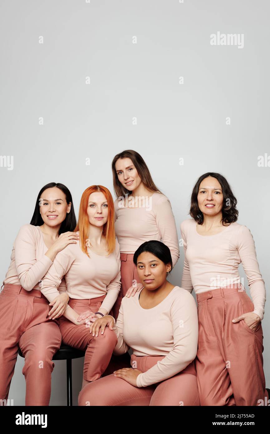 Group photo of multi-ethnic women on grey background Stock Photo - Alamy