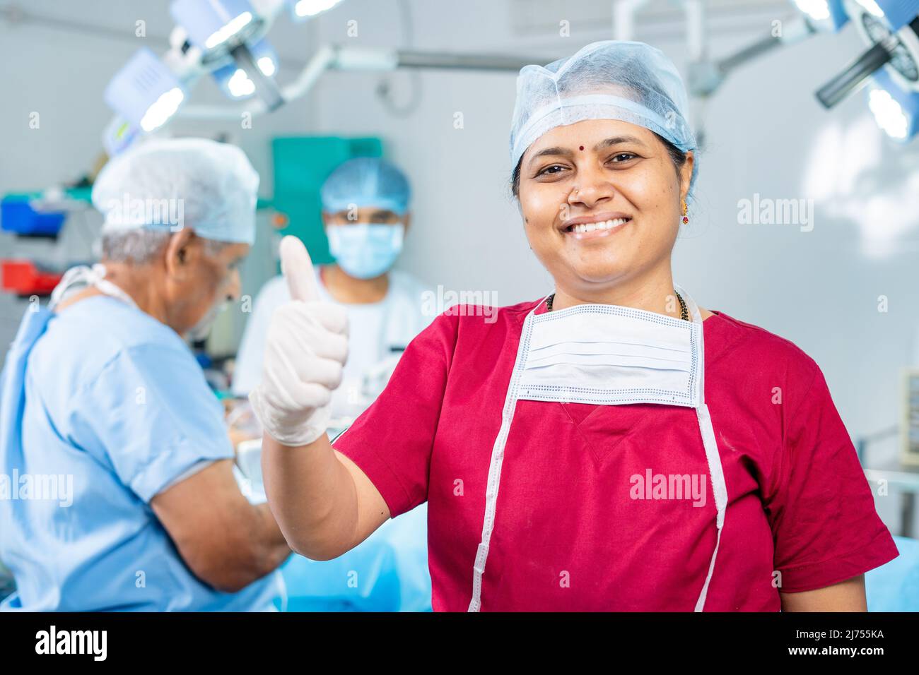 Happy woman surgeon showing thumbs up while working at operation ...