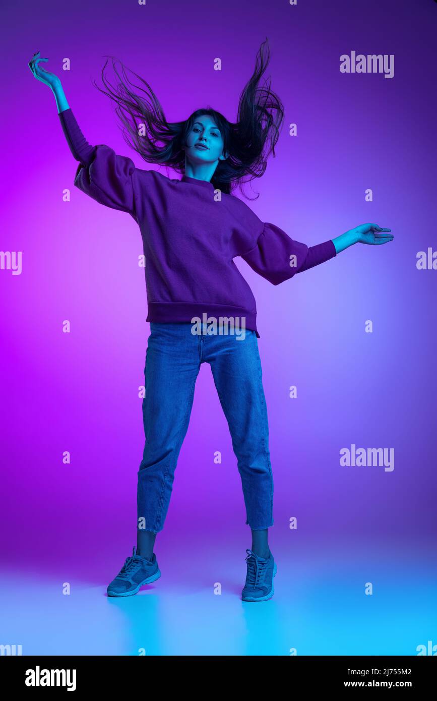 Full-length portrait of young excited girl, student jumping isolated ...