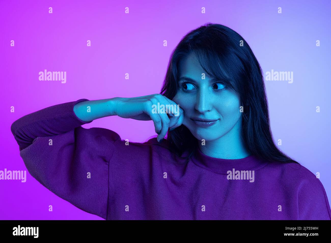 Young funny girl, student making crazy face isolated over purple studio ...