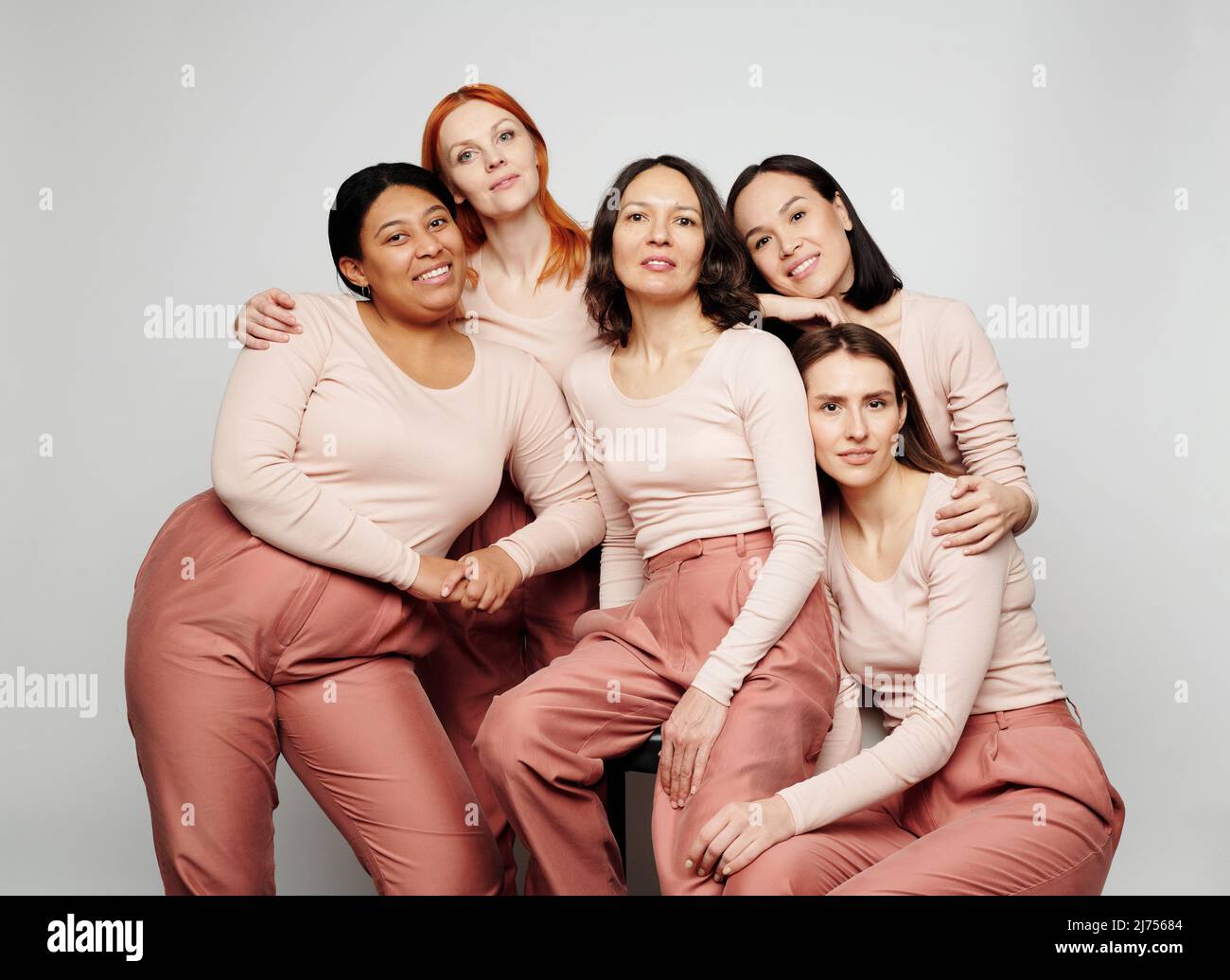 Portrait of smiling real women of different races and ages standing and ...