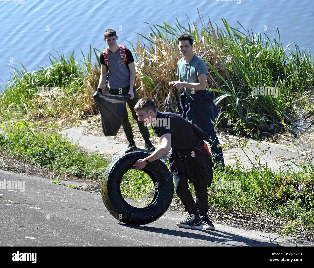 Activists pick up garbage along the embankment of the Pivdennyi Buh ...