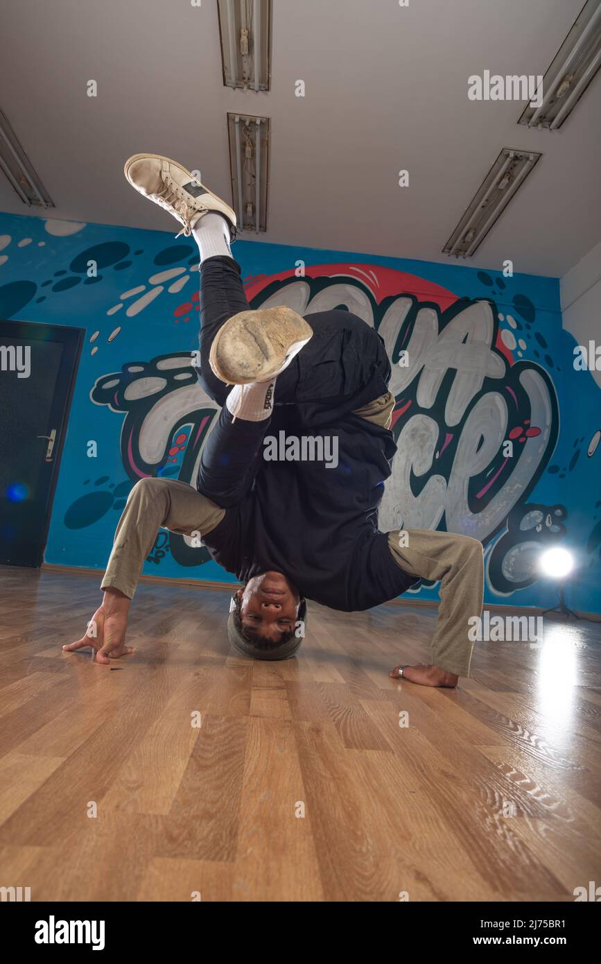 Modern rapper dancing in garage. Urban lifestyle, hip hop Stock Photo ...