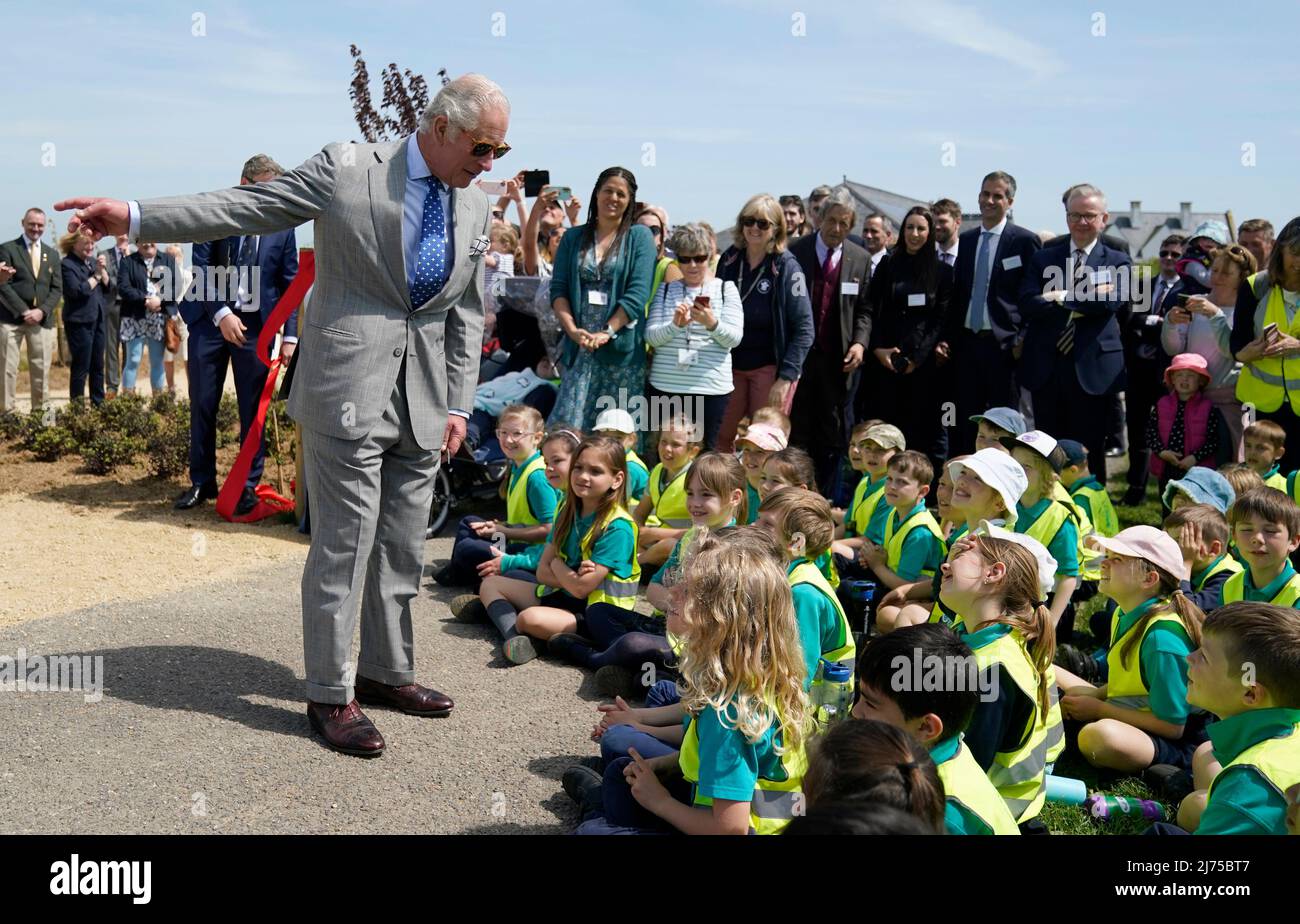 The Prince of Wales speaks to local school children during the opening ...