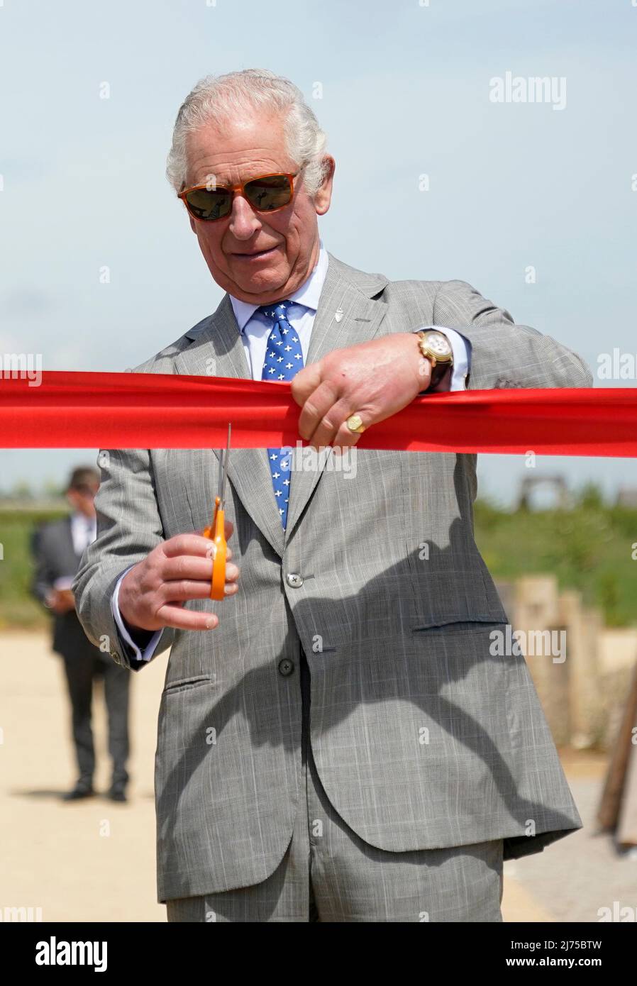 The Prince of Wales cuts the ribbon at the of the Great Field play area ...