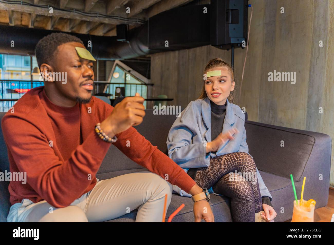 Multiracial friends are talking while guessing their word Stock Photo ...