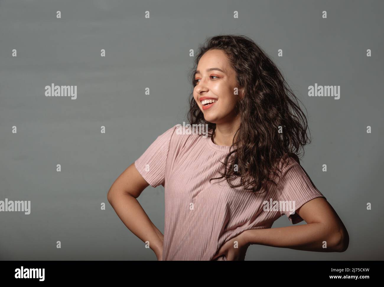 Studio body shot of a fashion female model posing in modern clothing ...