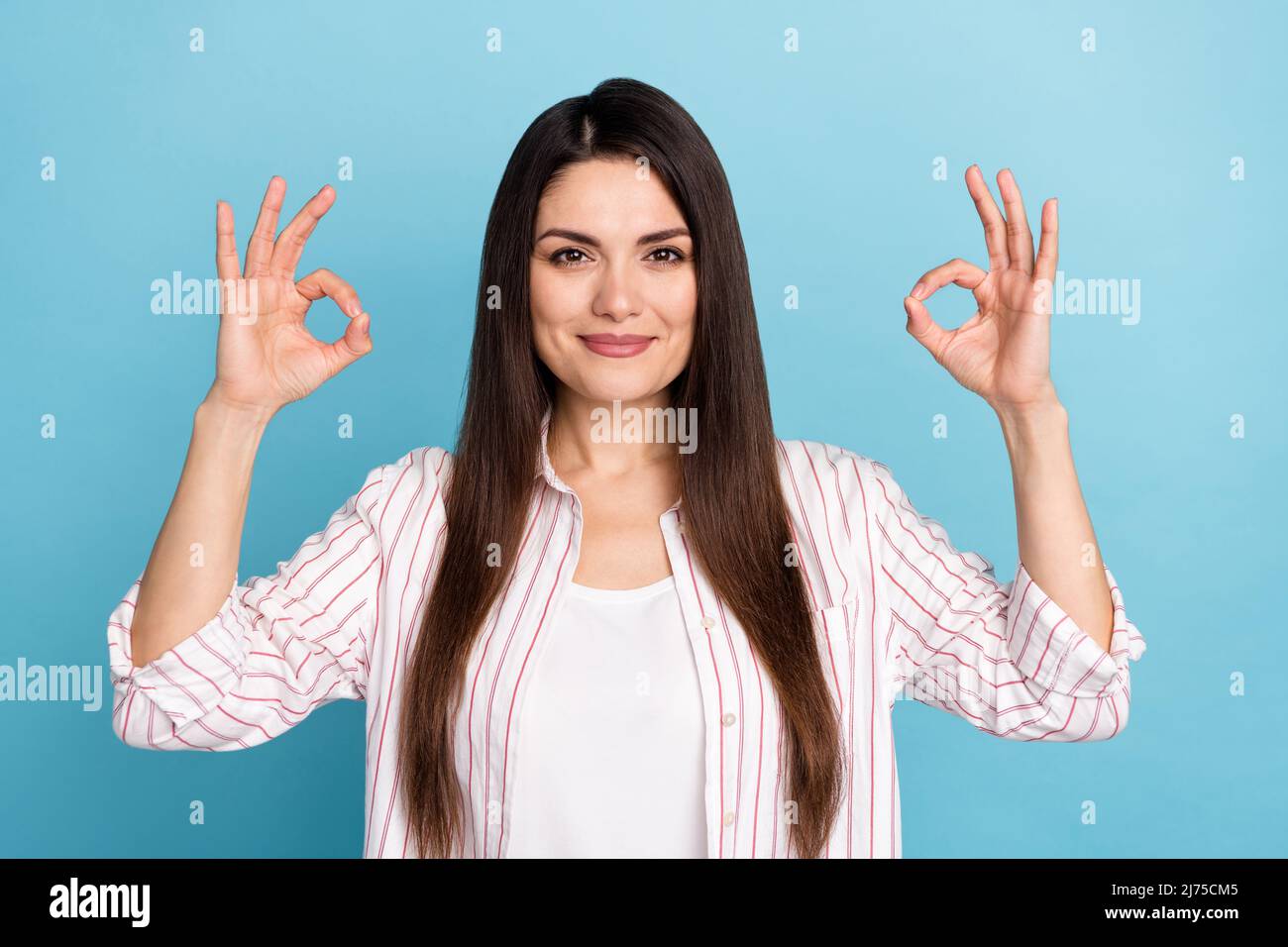 Portrait of attractive cheerful long-haired girl showing double ok-sign ...