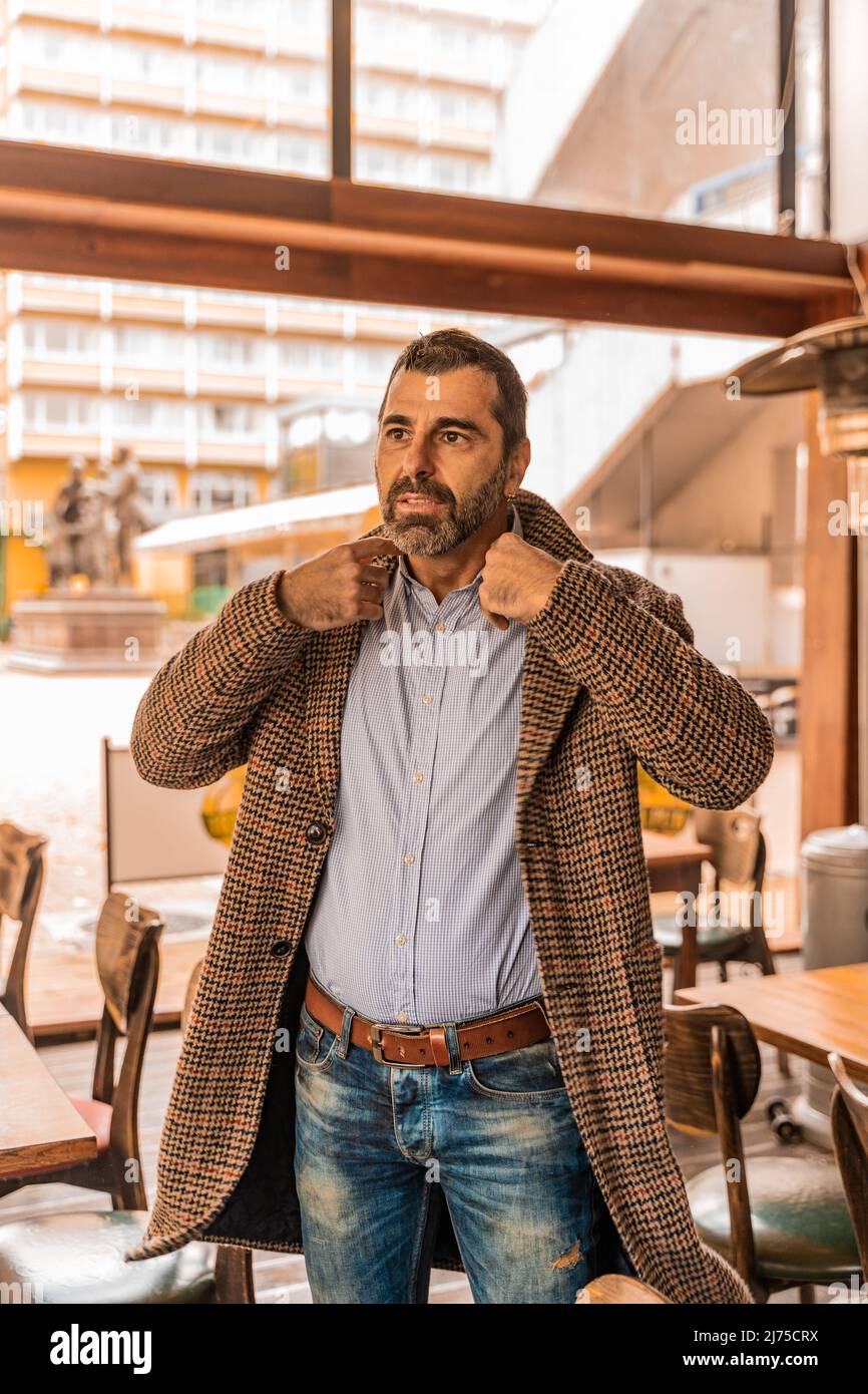 Senior and handsome businessman is standing and gettting ready to leave ...