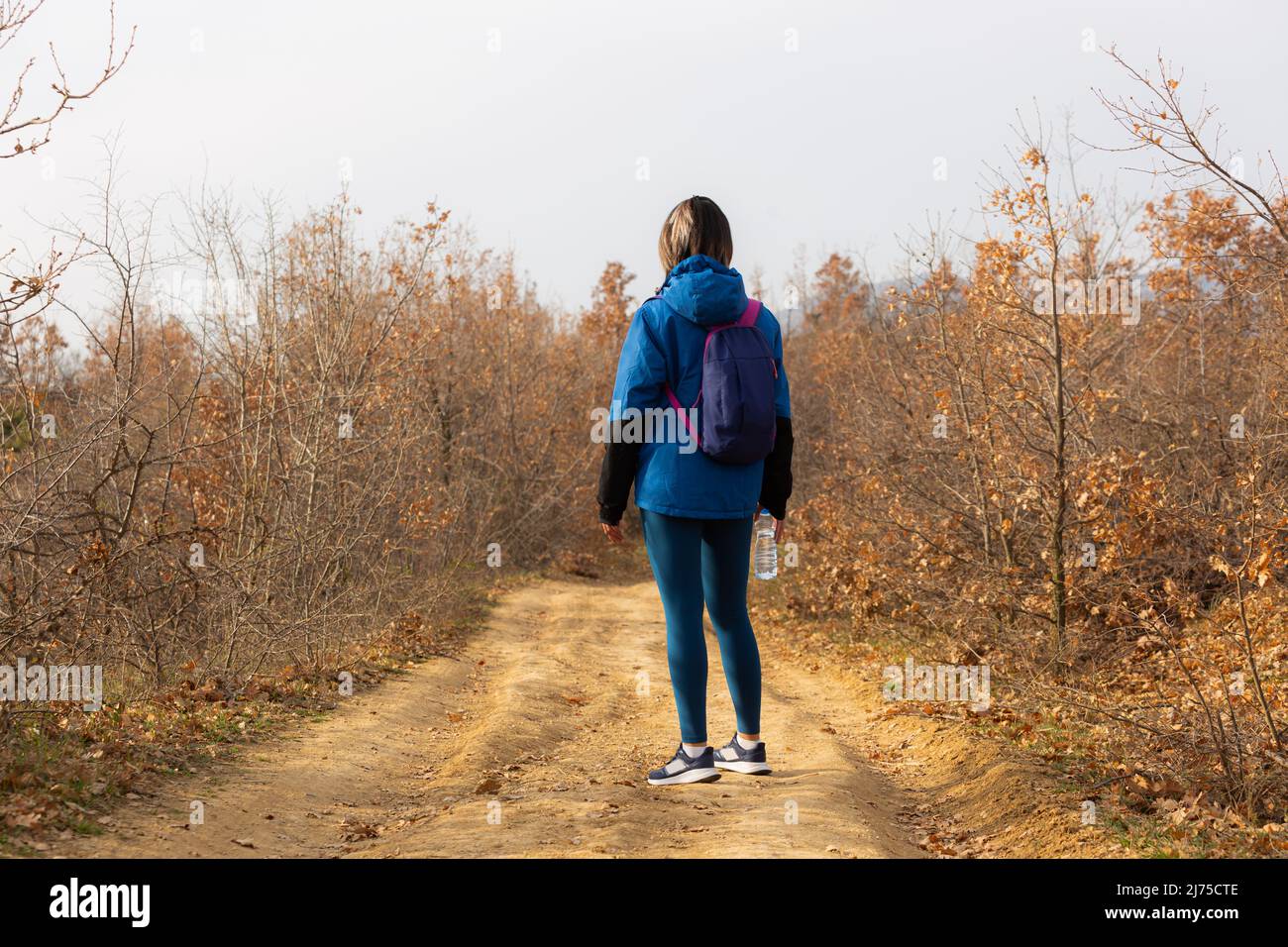 Amazing and active woman is standing alone and smiling while preparing ...