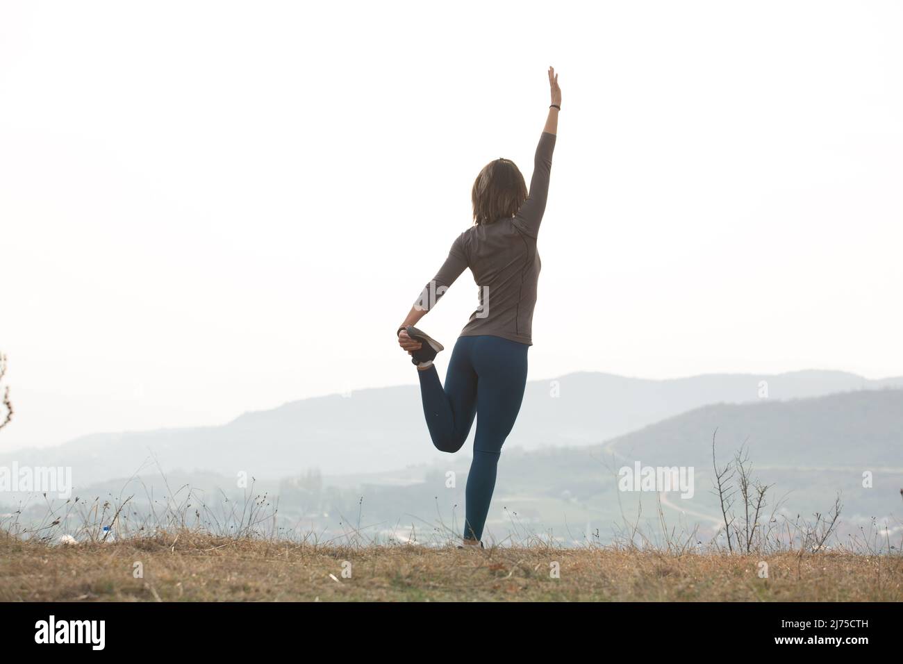Amazing and active woman is stretching before her training Stock Photo ...