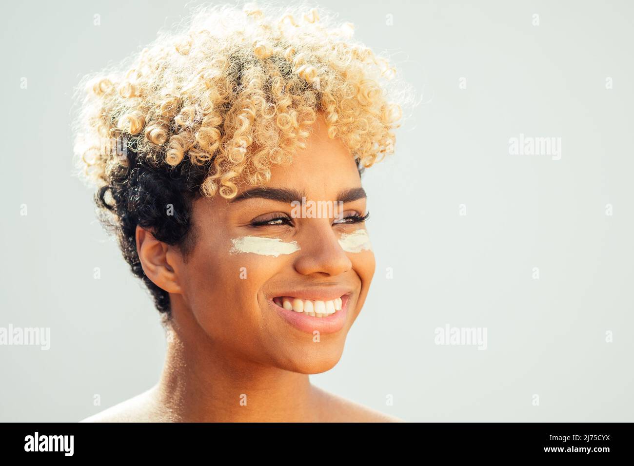 cute hispanic girl apply tone cream on perfect skin . anti acne concept ...