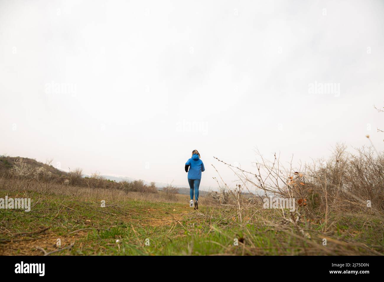 Strong girl running in nature Stock Photo - Alamy