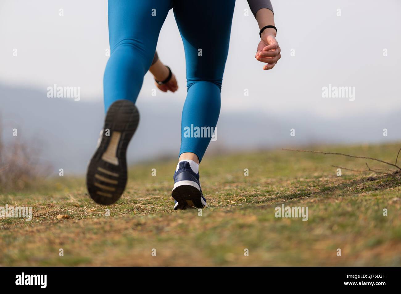 Amazing and active woman is running fast, close up at the shoes Stock ...