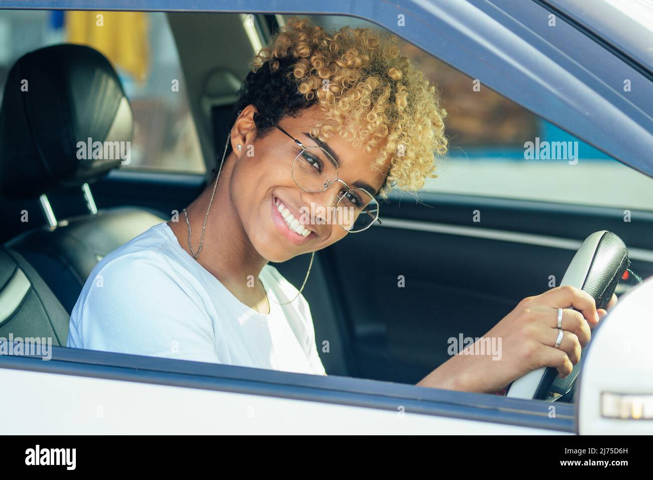 Beautiful multiracial young african american girl driving first car ...