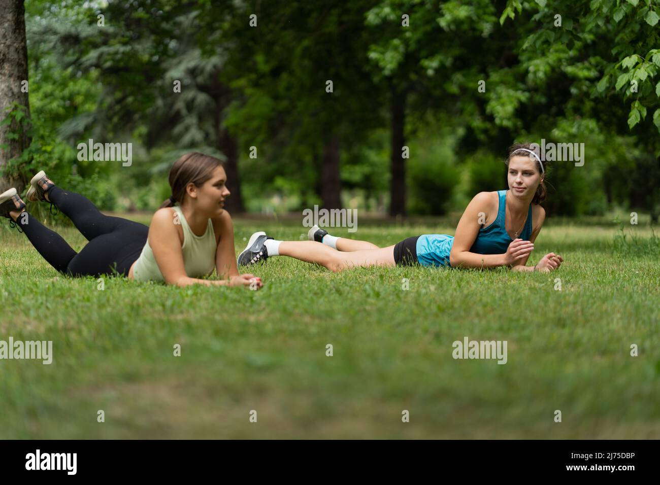 Two sweet and attractive girls are getting ready for the yoga pose ...