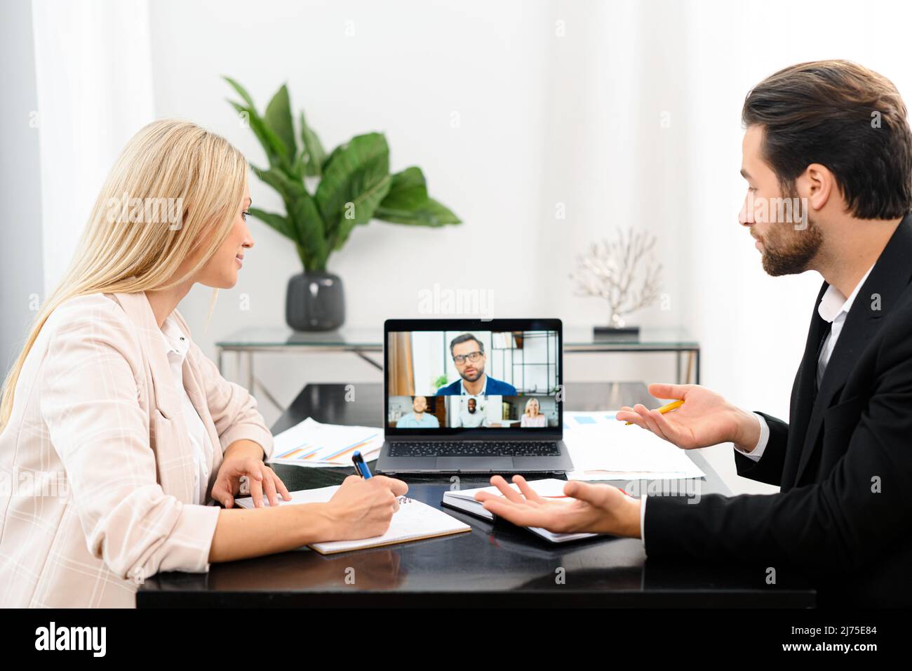 Online interview concept. Side view of the male and female is having ...