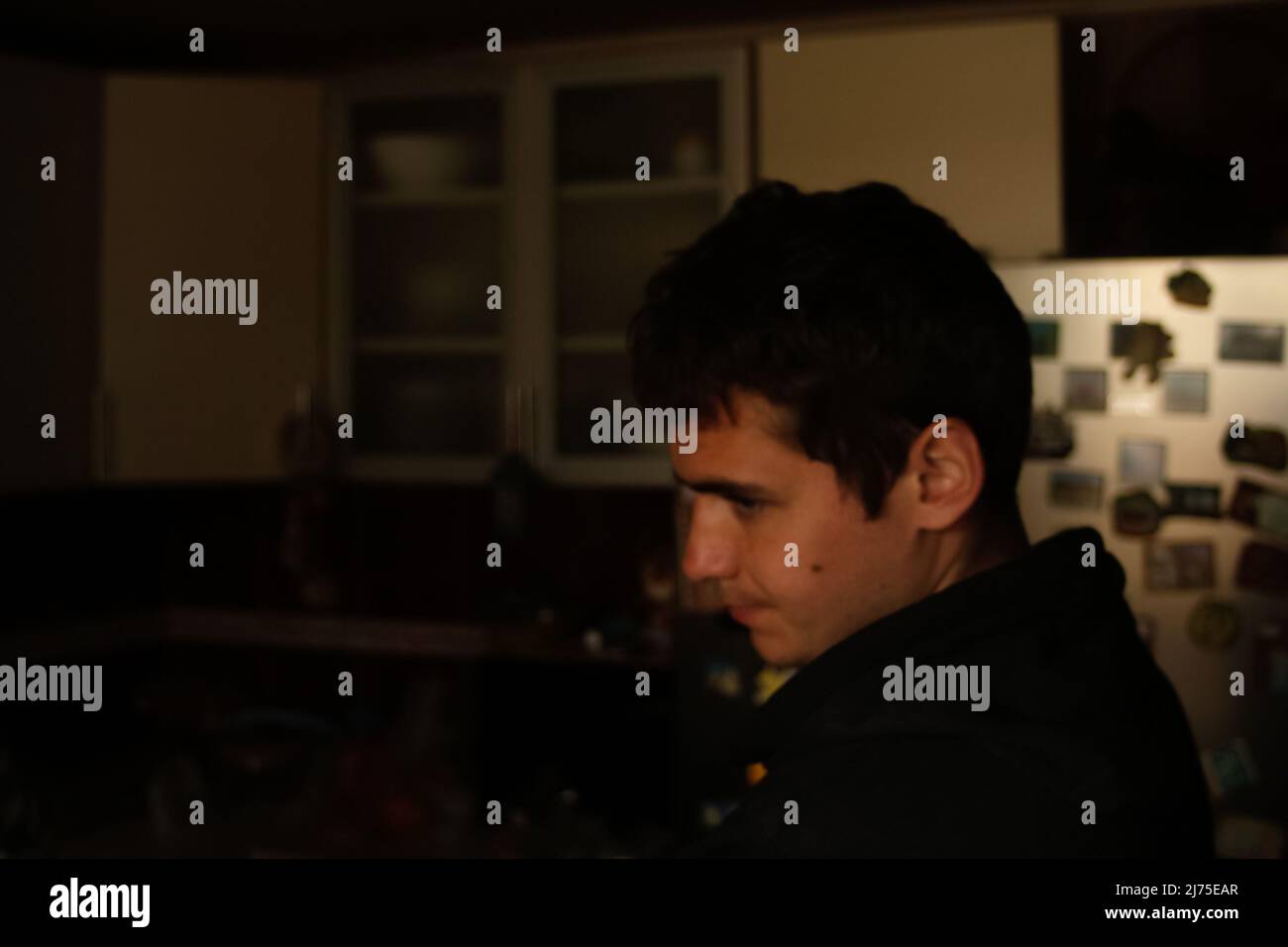 Defocus portrait of young man in dark kitchen. Millennial dark portrait ... Defocus portrait of young man in dark kitchen. Millennial dark portrait ...
