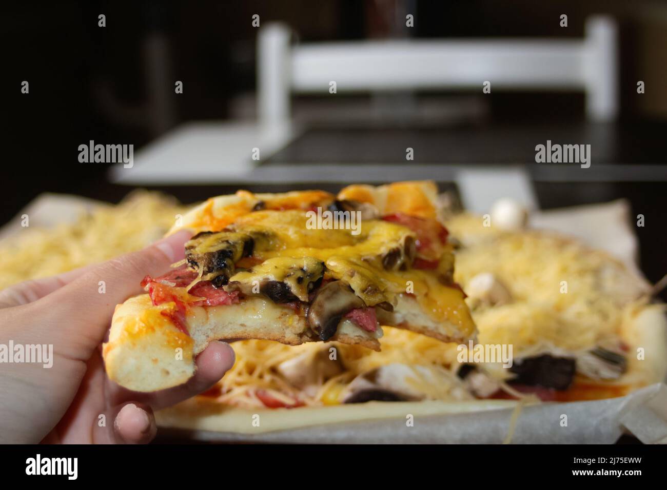 Defocus closeup piece of pizza with freshly grated mozzarella cheese ...