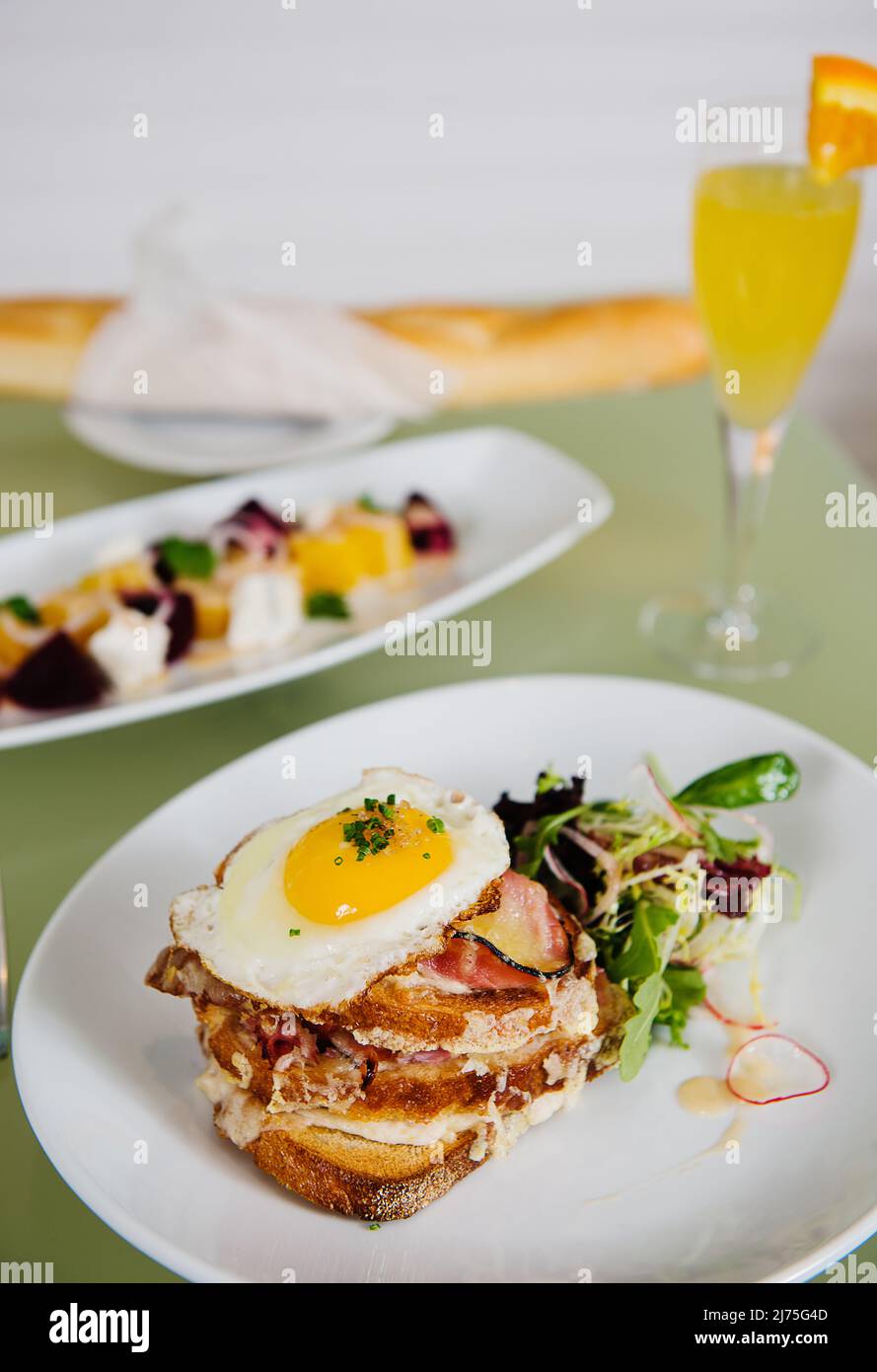Croque Madame (toast topped with dry-cured ham, grilled cheese and a ...