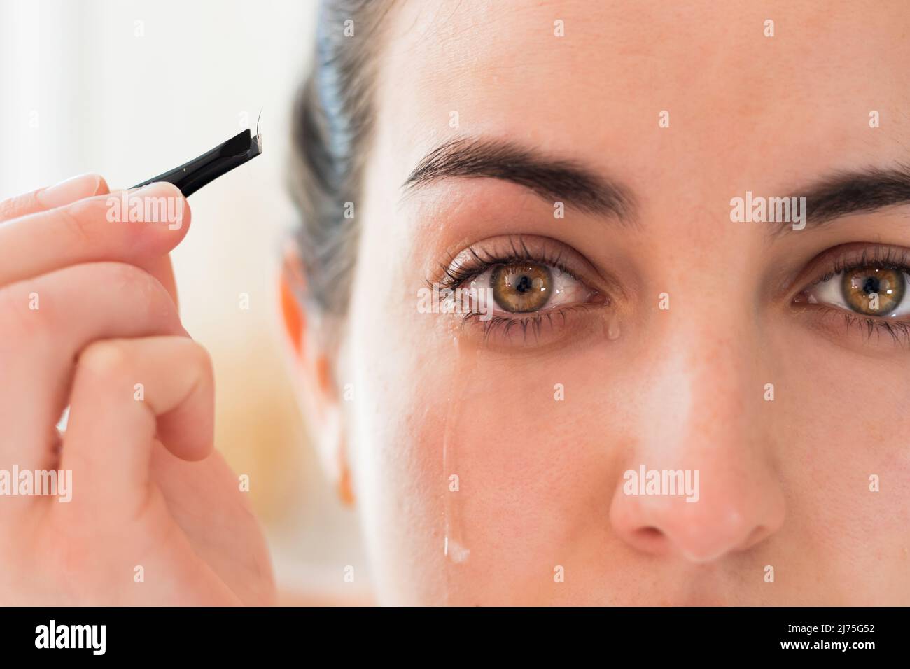 Close up macro portrait of yellow color eyes woman crying on pain with ...