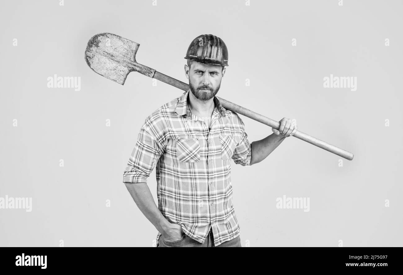 handsome man laborer in construction safety helmet and checkered shirt ...