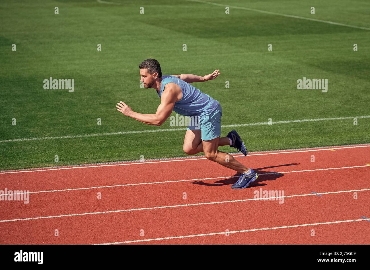 Runner at finish. Athlete runner prepare to race at stadium. Running ...