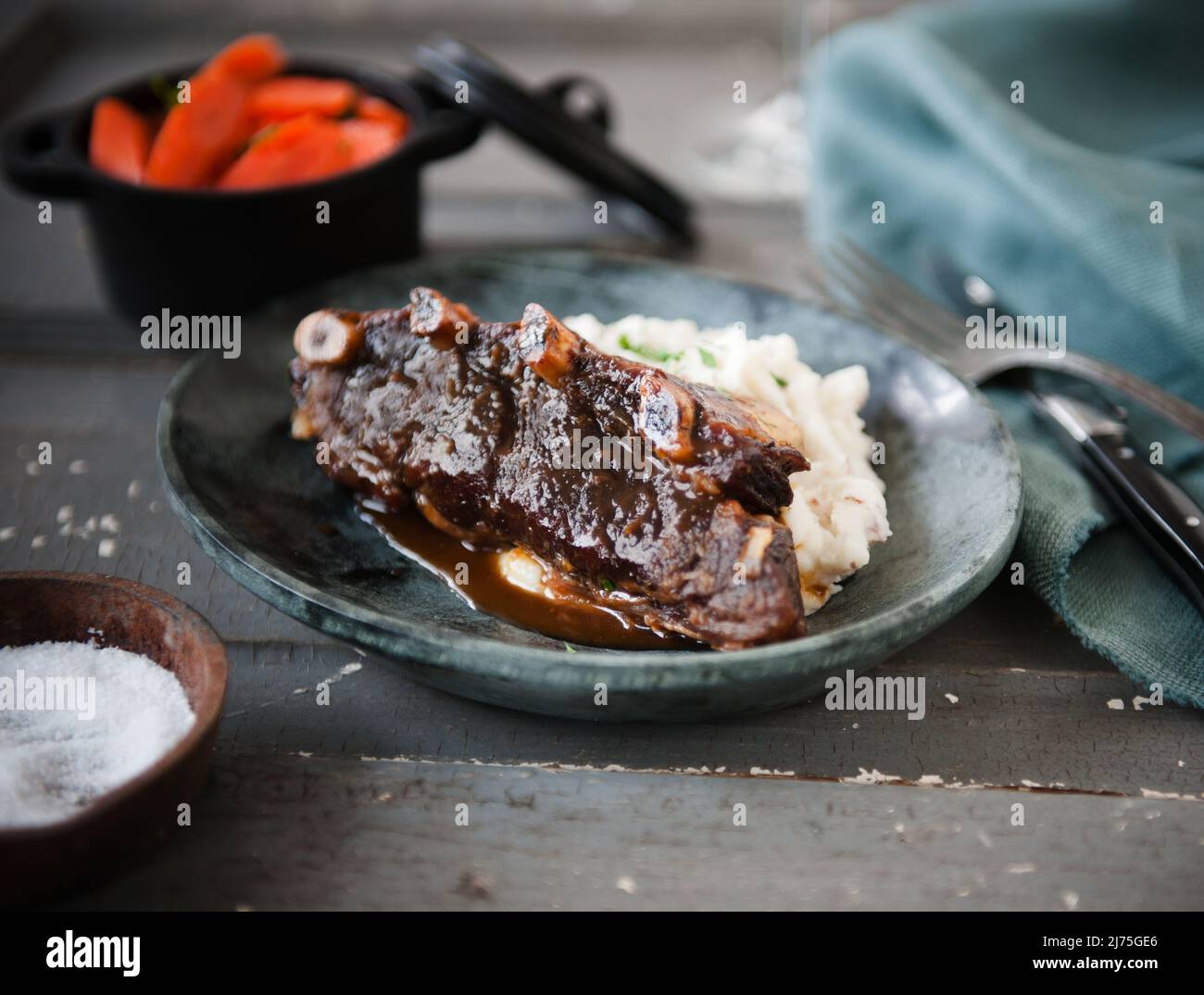 Braised Ribs with Mashed Potatoes; Fork Piercing the Meat Stock Photo ...