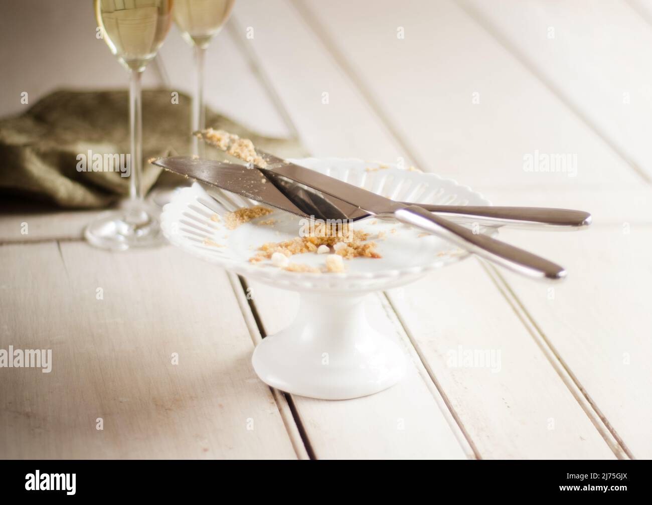 Empty cake stand with crumbs and cutlery Stock Photo - Alamy