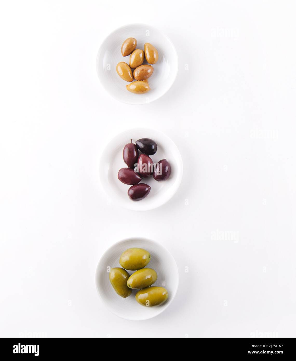 Three Types of Olives in Small White Dishes Stock Photo - Alamy