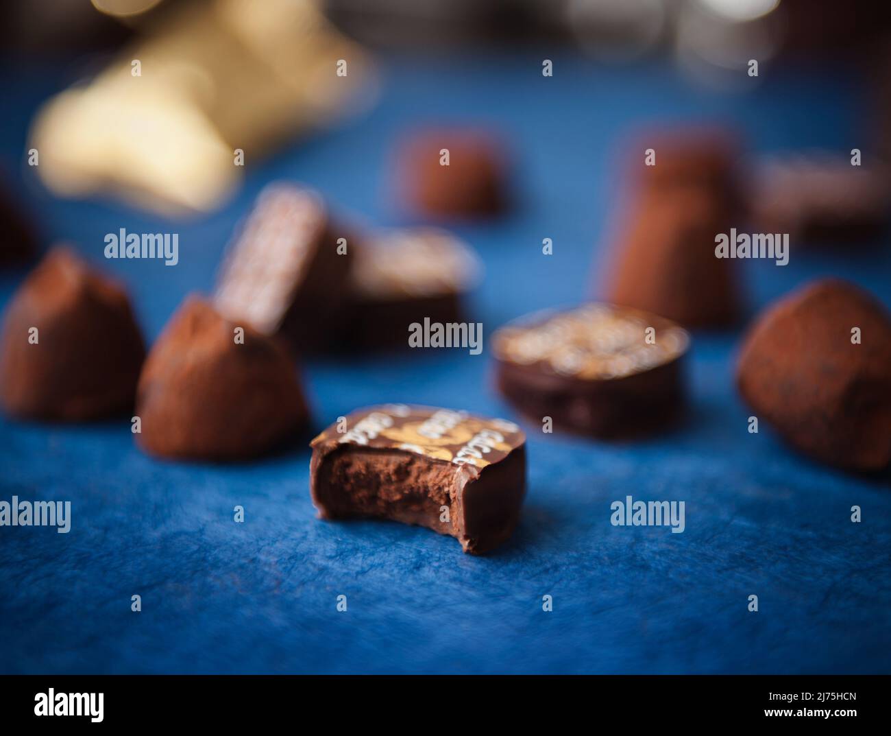 Assorted Chocolates on a Dark Blue Background Stock Photo - Alamy
