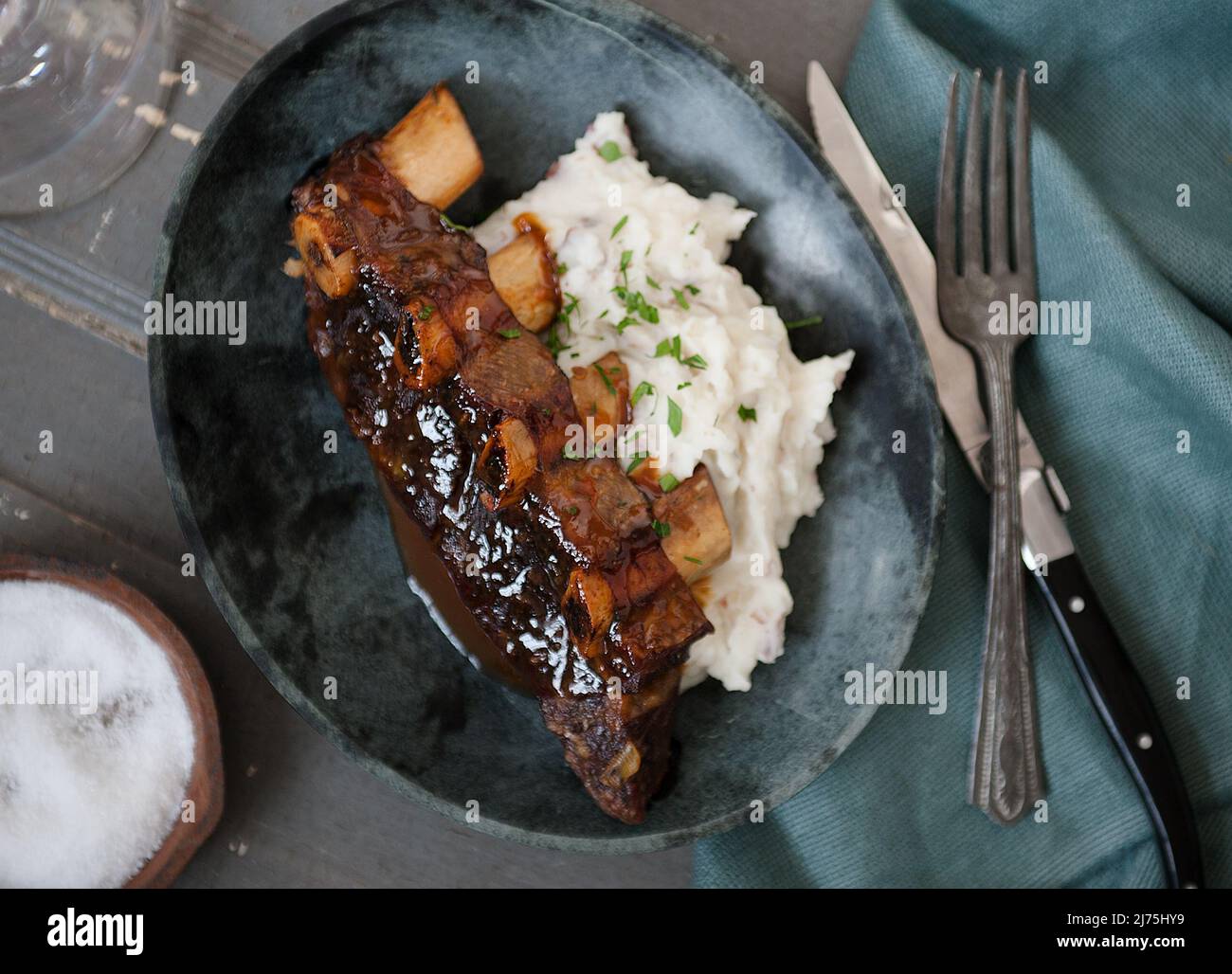 Braised Ribs with Mashed Potatoes; Fork Piercing the Meat Stock Photo ...