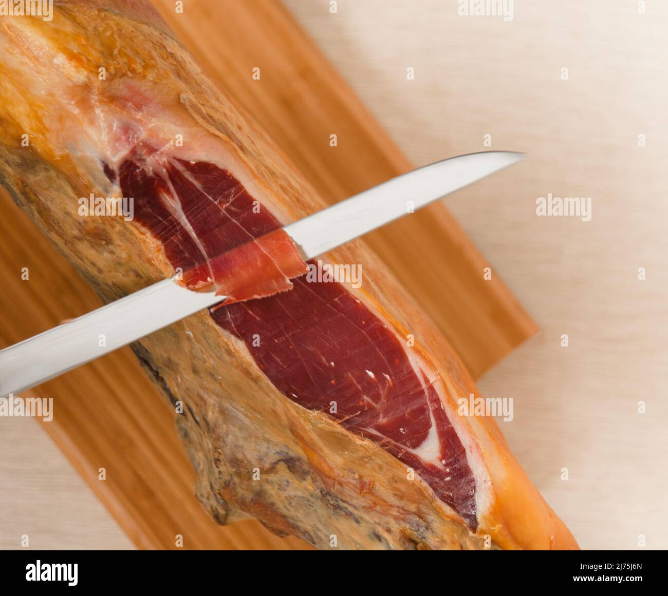 Jamon being cut Stock Photo - Alamy