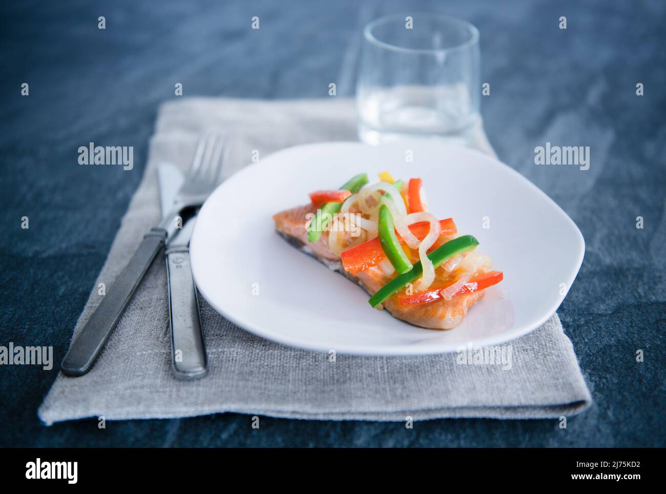 Salmon topped with onion and pepper Stock Photo - Alamy