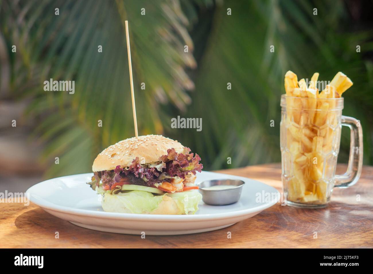 prawns burger and french fry on table tropical sea ,palms tree and ...