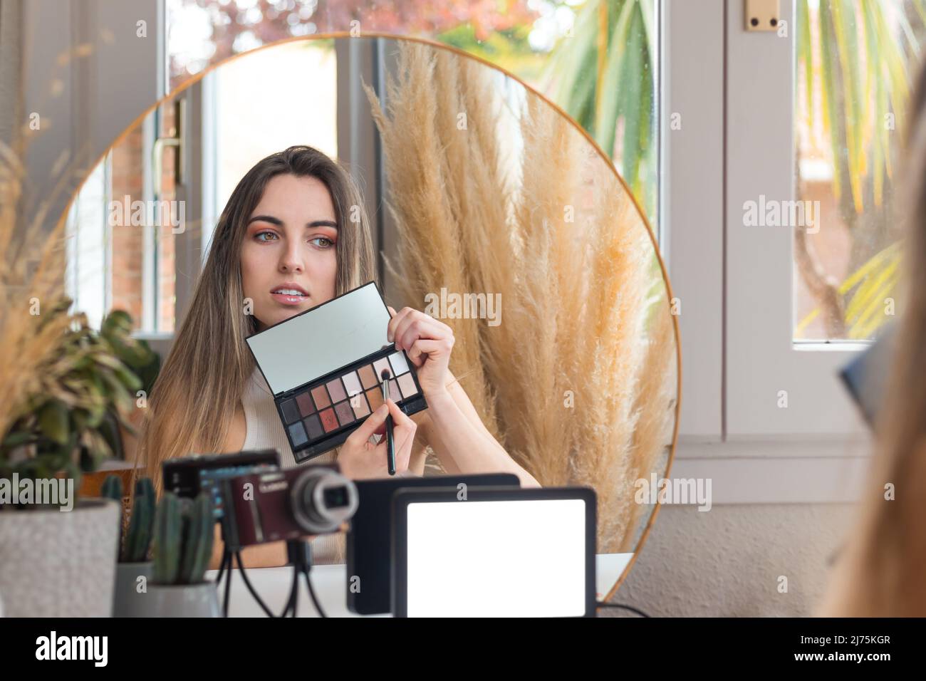 Female vlogger recommends eye shadow palette showing her favourite ...