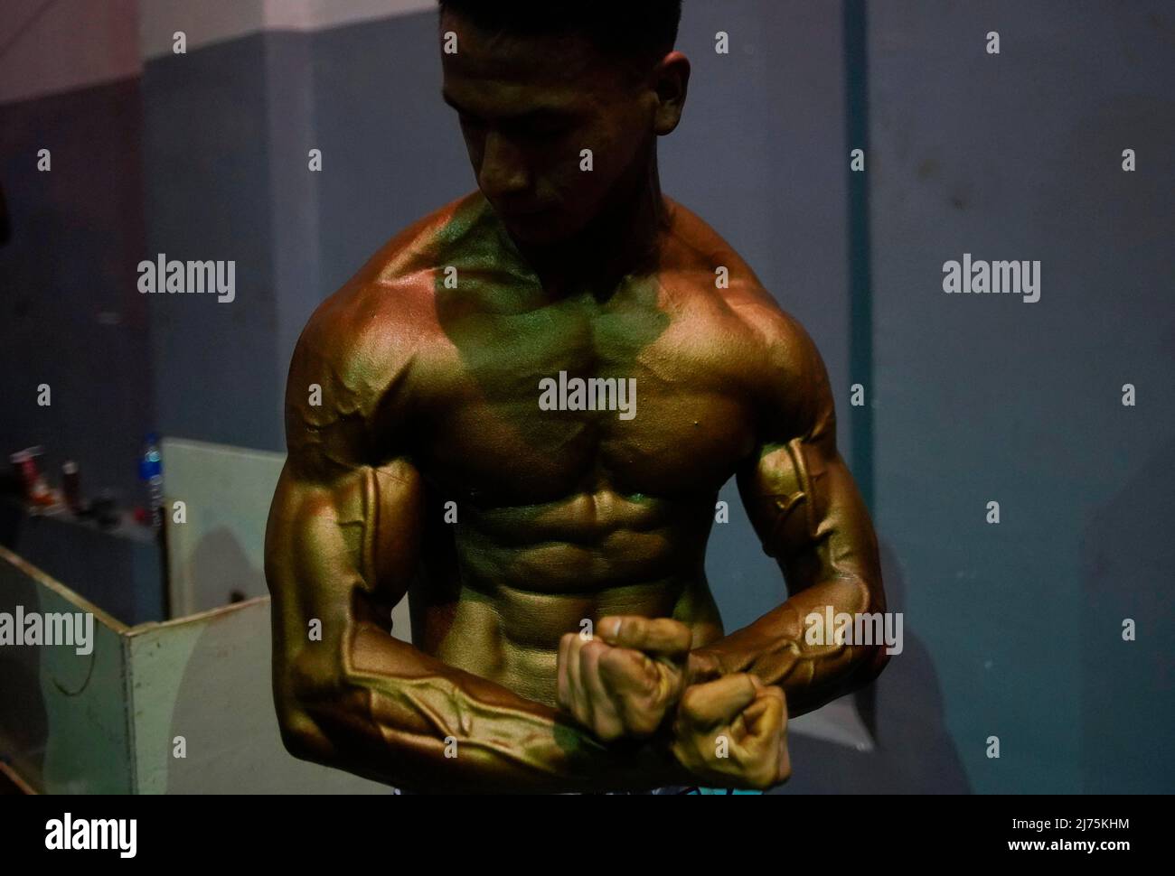 May 6, 2022, Kathmandu, Nepal: A bodybuilder pumps his body backstage ...