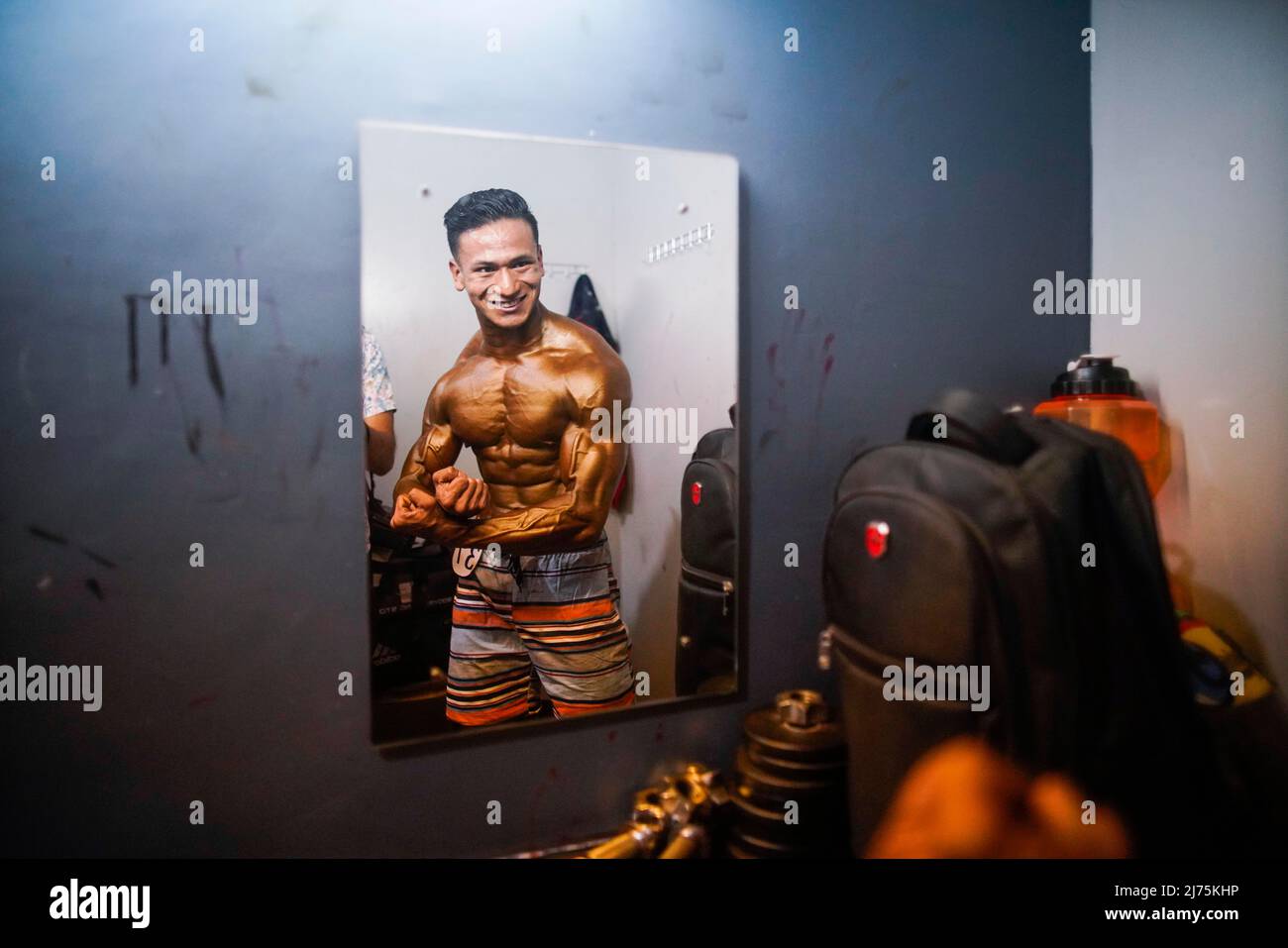 May 6, 2022, Kathmandu, Nepal: A bodybuilder flexes backstage during ...