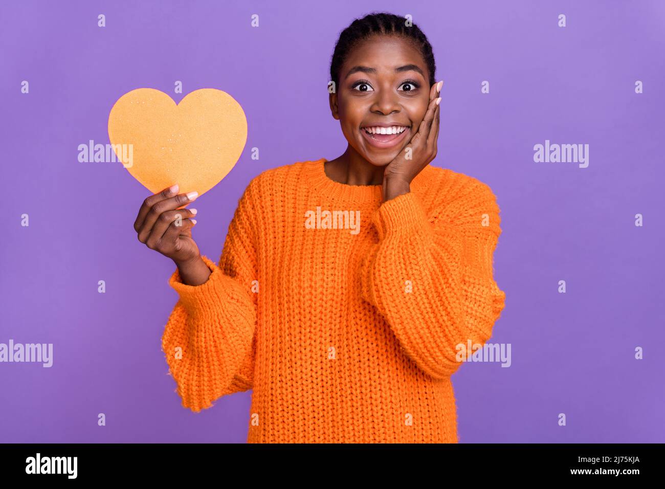 Photo of young cheerful girl hand touch cheek receive present heart ...