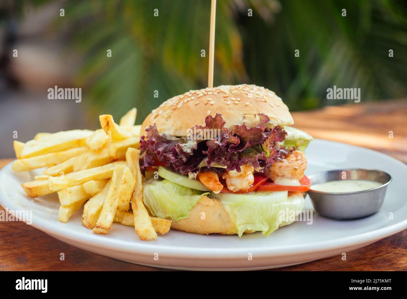 prawns burger and french fry on table tropical sea ,palms tree and ...